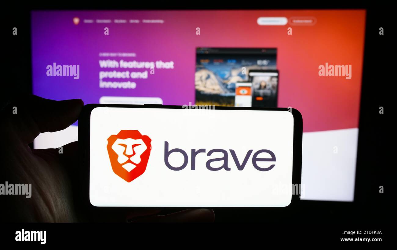 Person holding cellphone with logo of US web browser company Brave ...