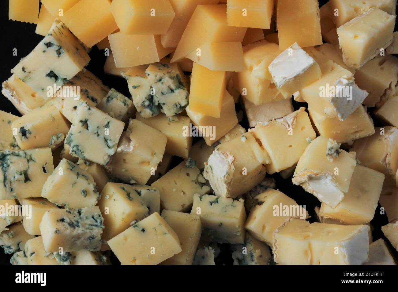 Assorted blue and hard cheeses, diced Stock Photo - Alamy