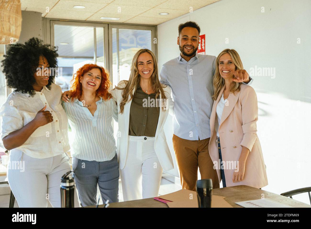 Diverse business team smiling while standing together in the office ...