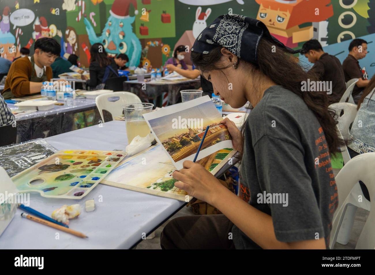 A participant is seen reproducing an image with watercolor painting, at ...