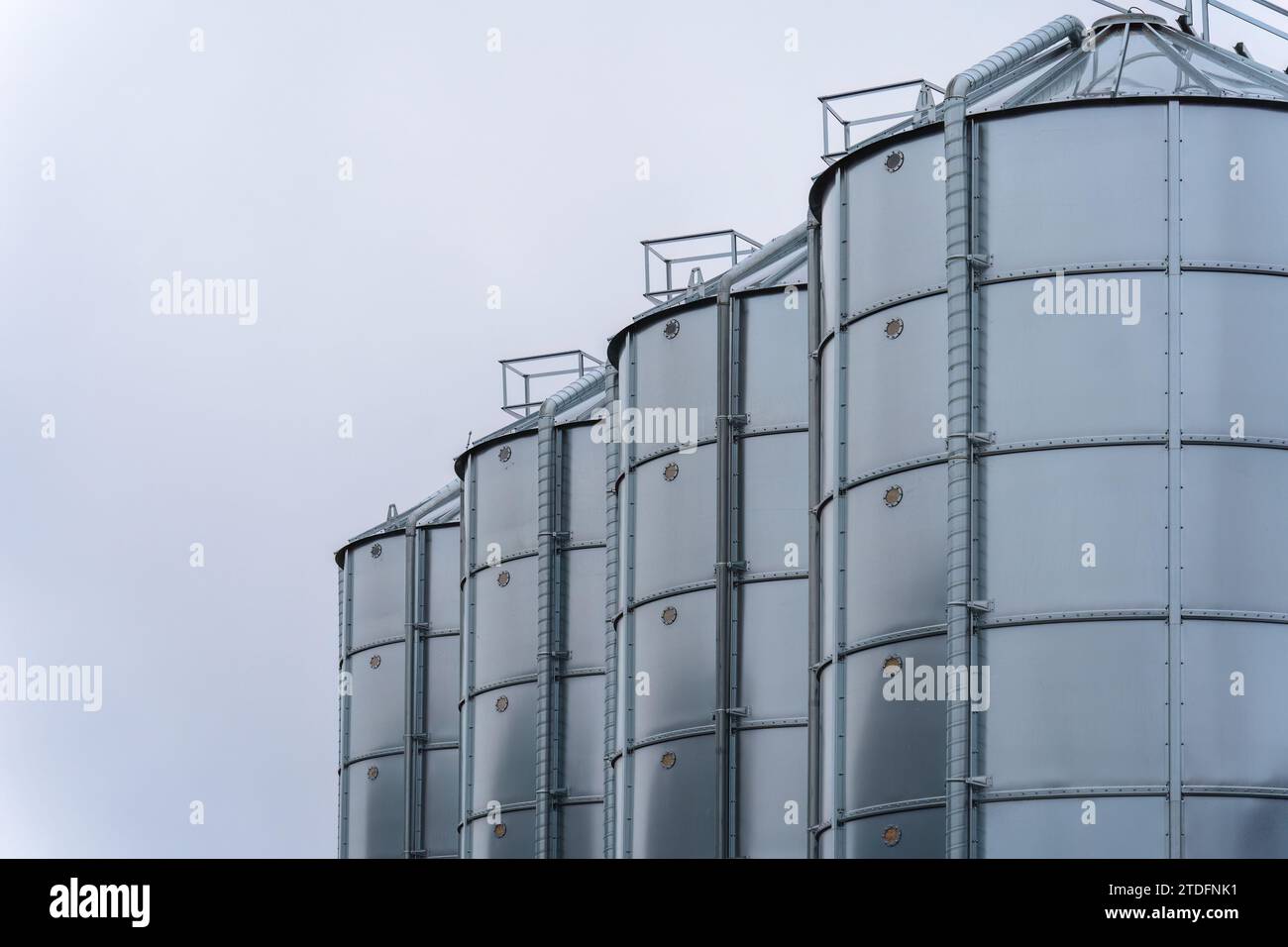 Stainless steel industrial silos with overcast sky background Stock ...