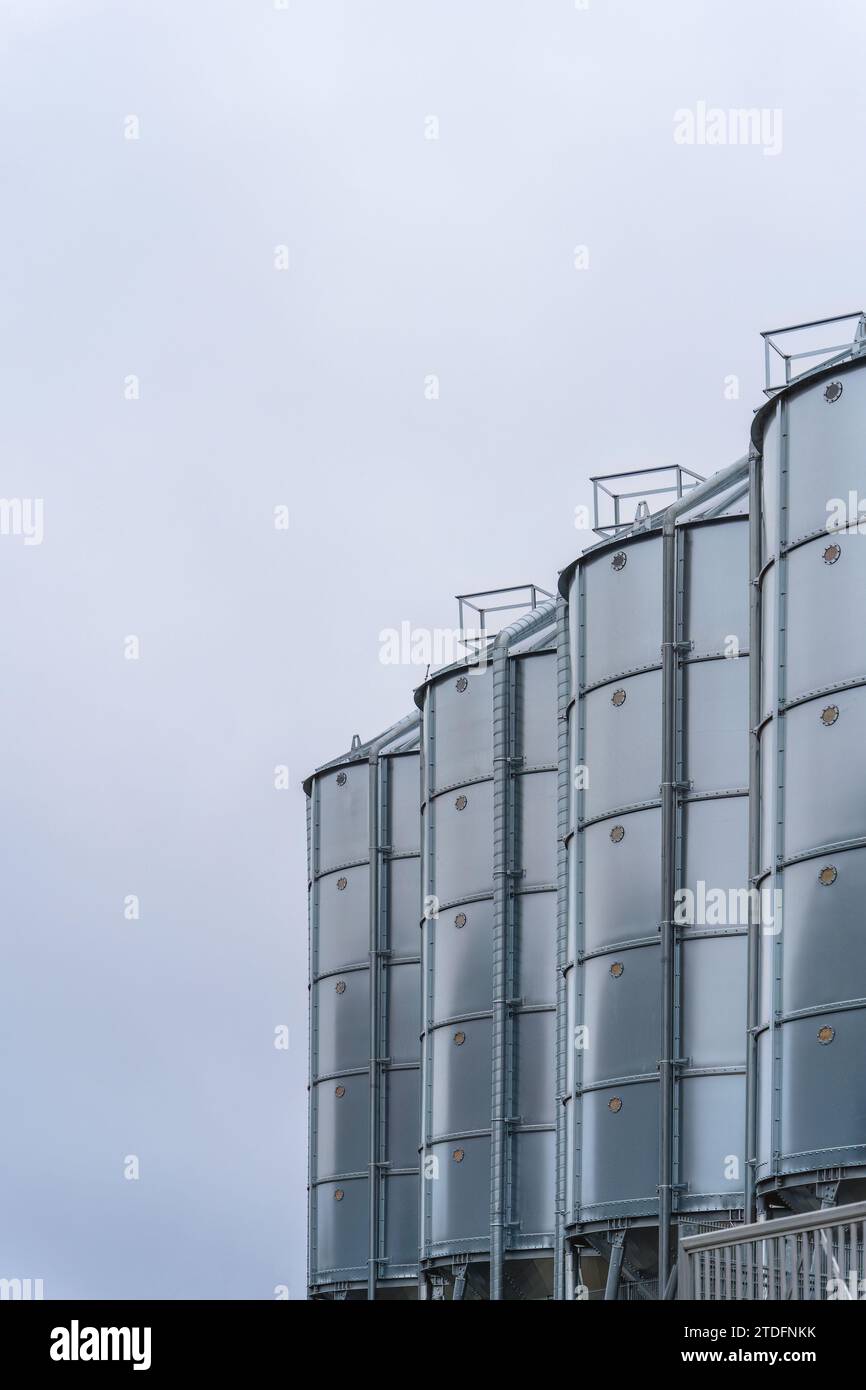 Stainless steel industrial silos with overcast sky background Stock ...