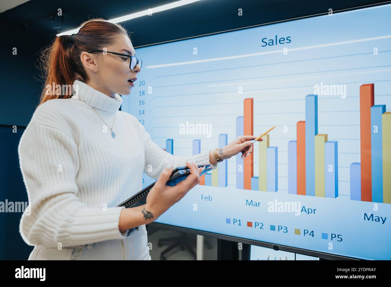 Experienced businesswoman presenting sales graph charts or growth to a ...