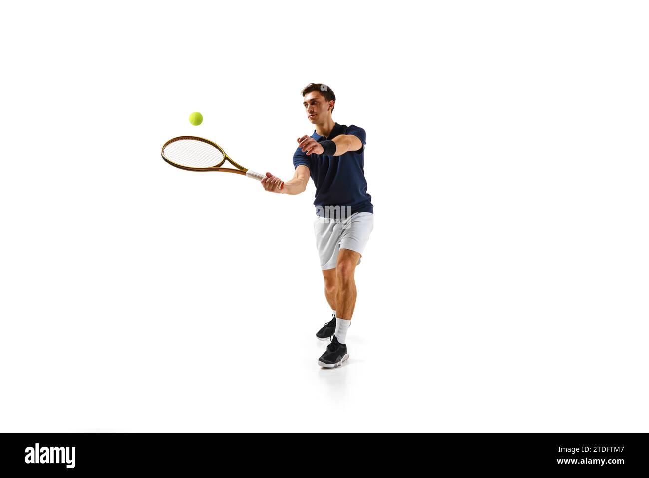 Competitive man in his 30s, tennis player in motion, hitting ball with ...