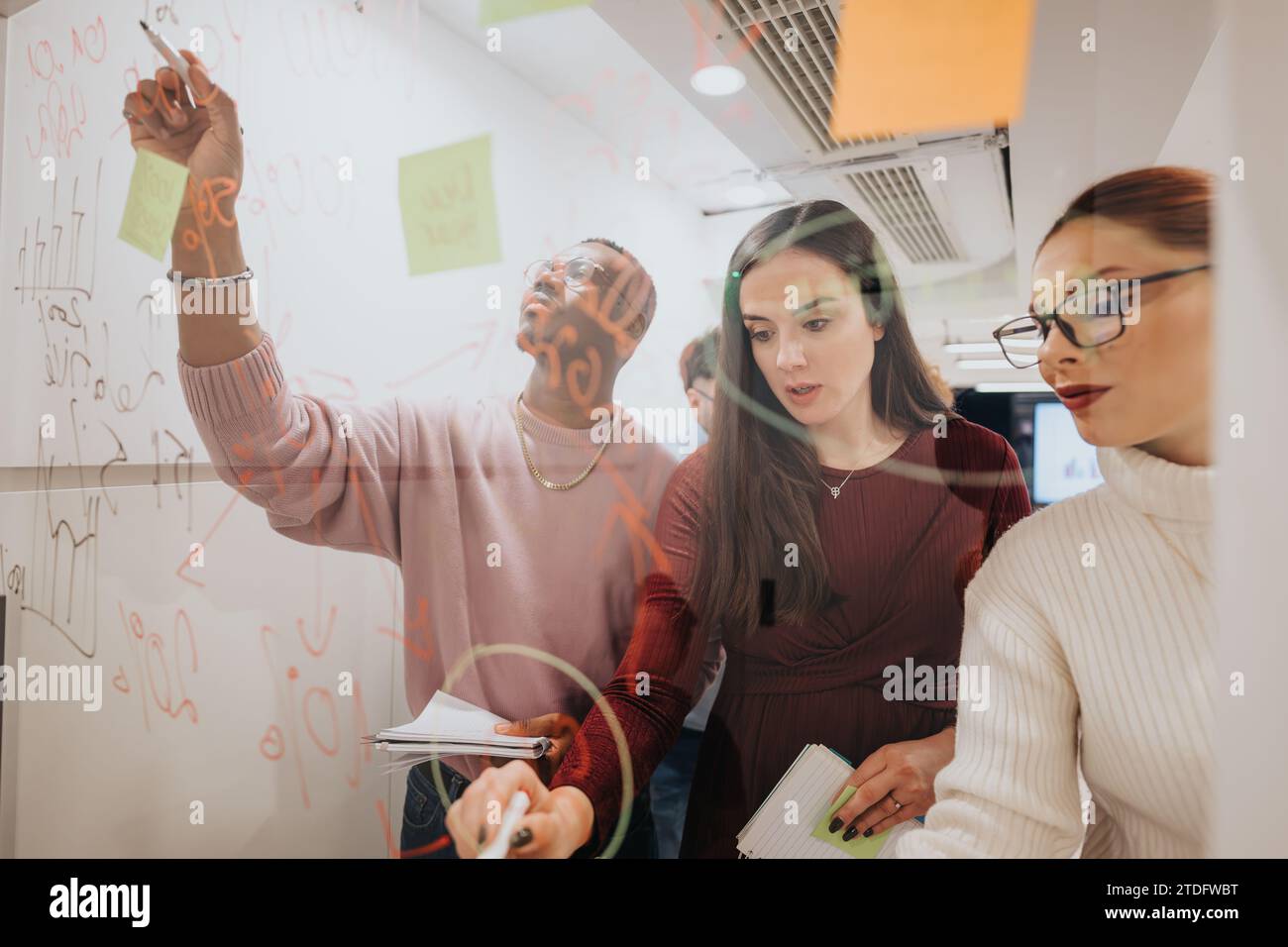 Diverse business team collaborating on project development and problem ...