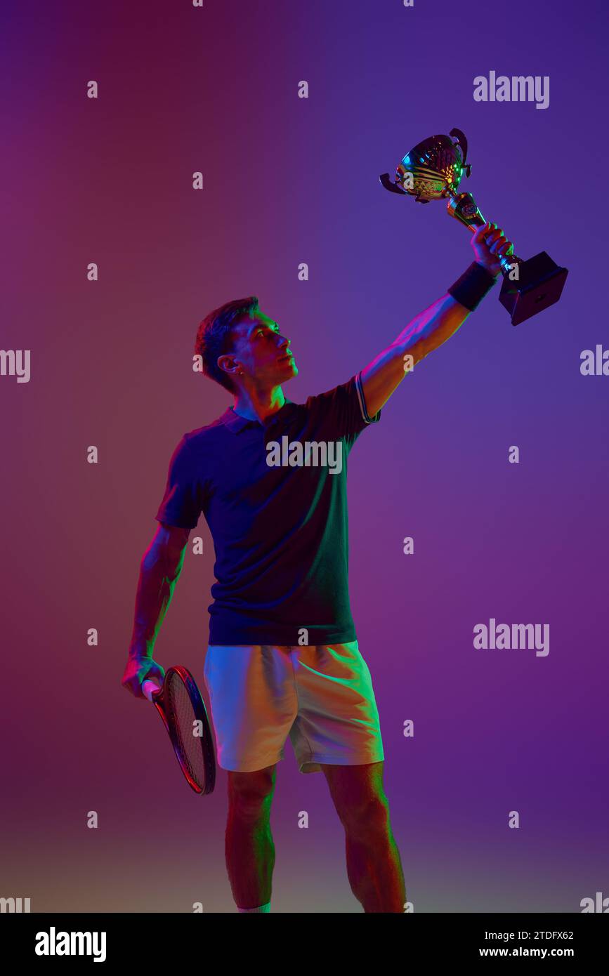 Winner, champion. Man, tennis player standing with racket, celebrating ...