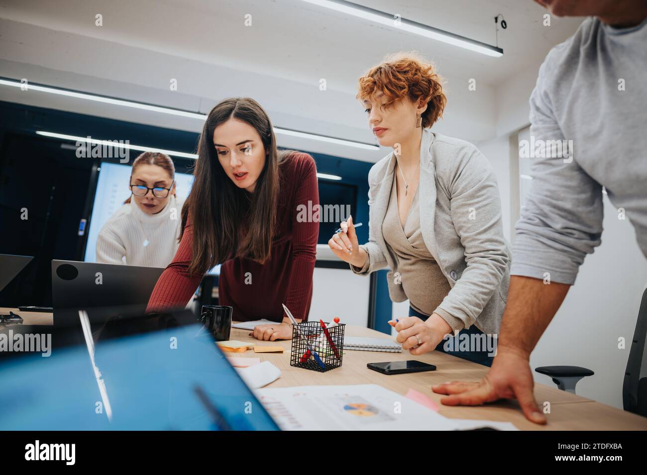 Successful businesspeople collaborating and sharing ideas in a dynamic ...