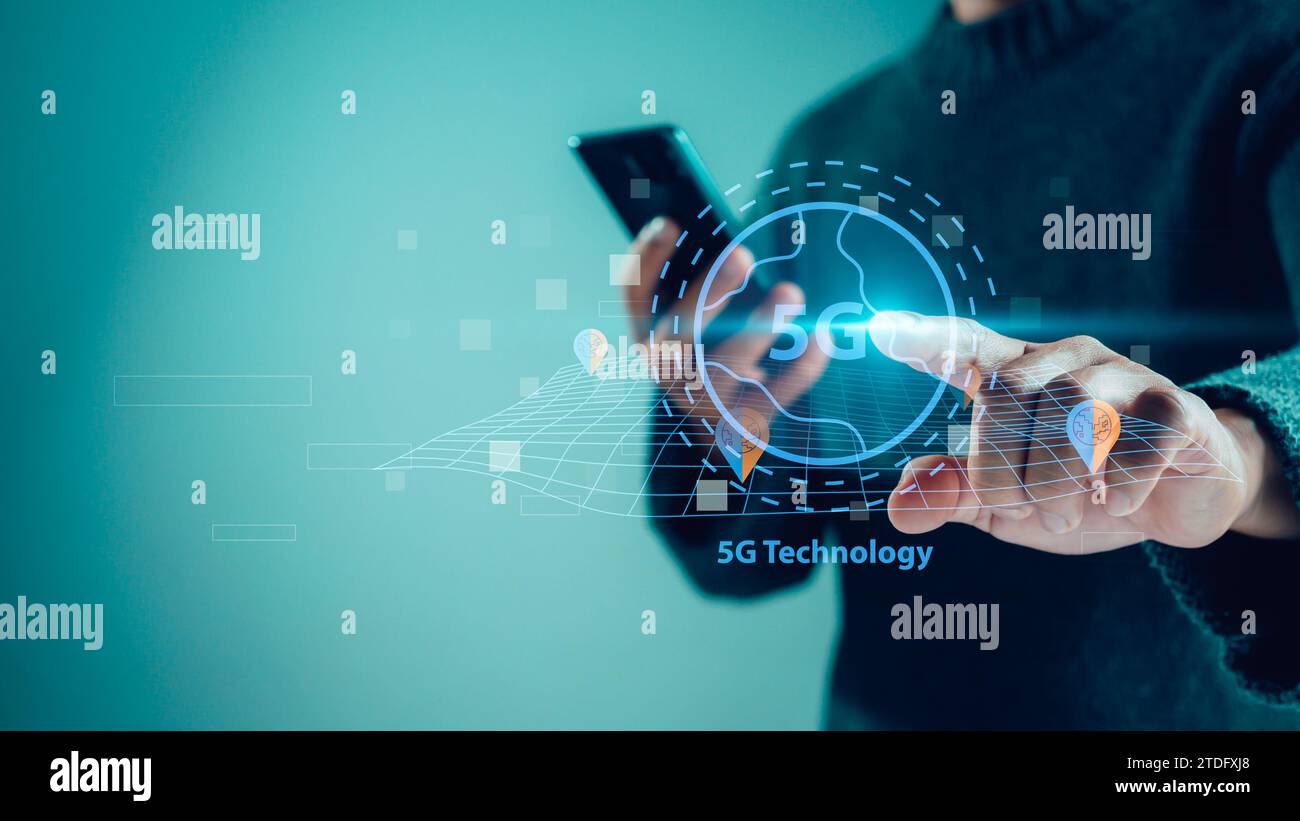 Close-up of human hand holding smartphone and pointing at 5G hologram, 5G wireless network ...