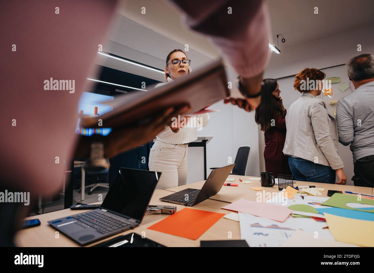 Multiracial team brainstorming successful business strategies in a ...