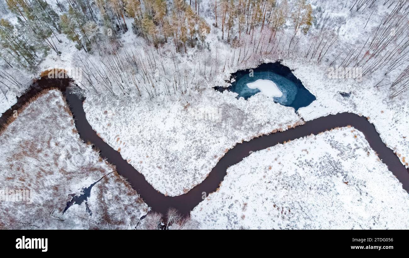 Aerial view of the river in Lithuanian forests, wild winter nature ...