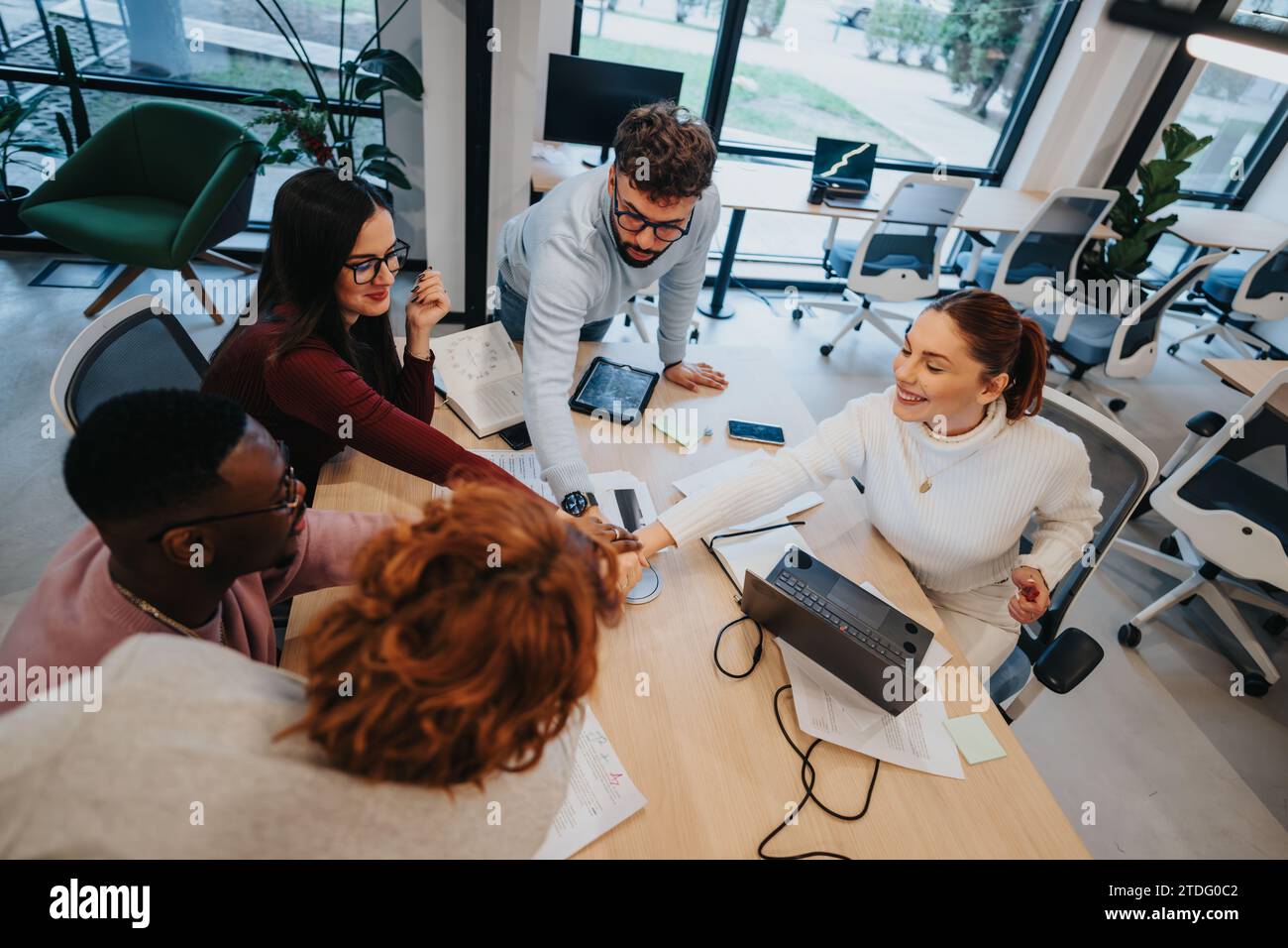 Business professionals celebrating a successful project, displaying ...