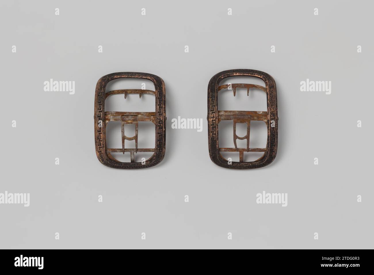 Rectangular and curved shoe spacer of gilded copper, decorated with a ...