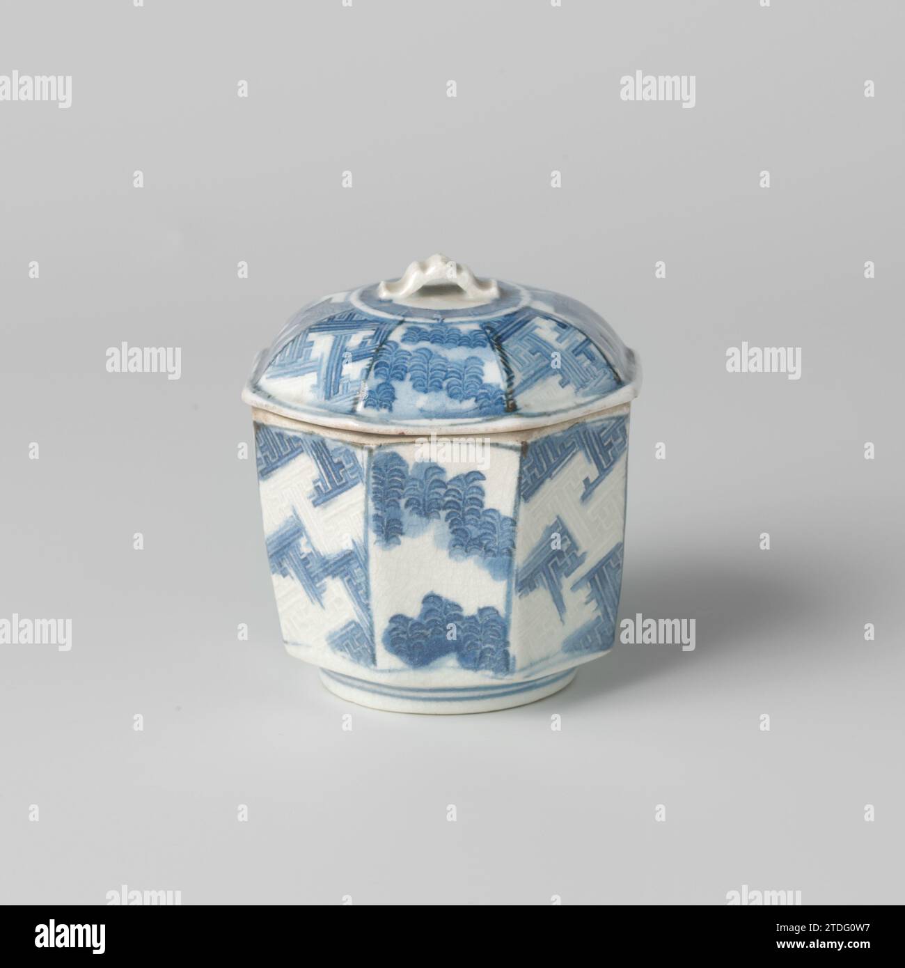 Octagonal covered jar with plants, bundles of bamboo and ornamental ...