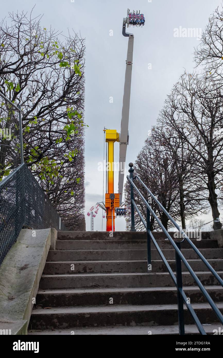 Paris, France. People enjoying a booster ride at a funfair against a ...