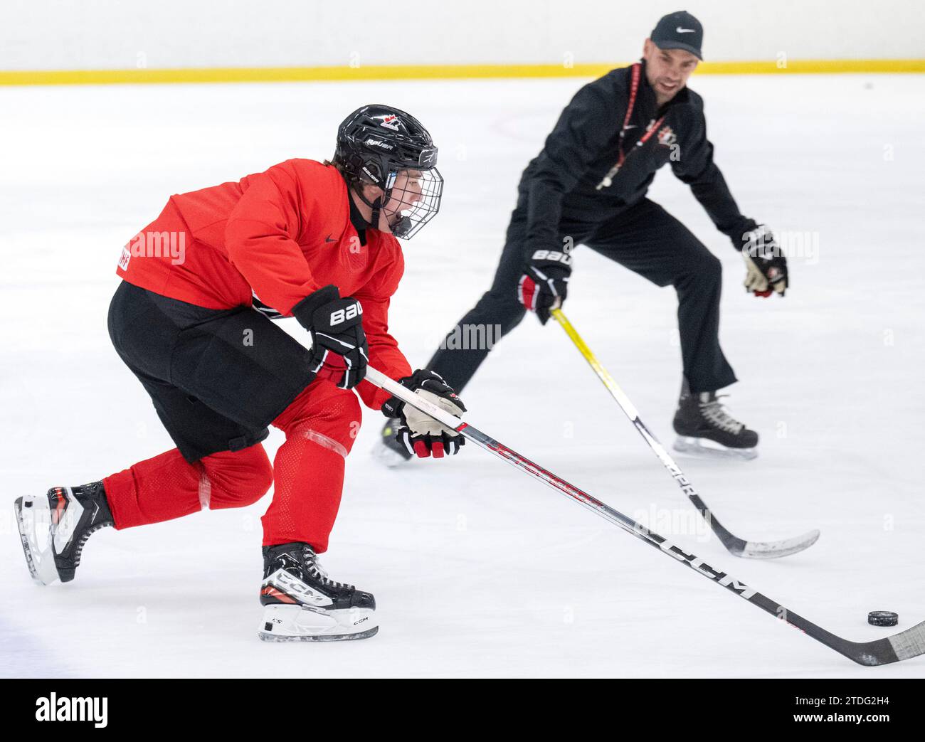 Macklin Celebrini (17) and Alan Letang, the national team captain, when ...