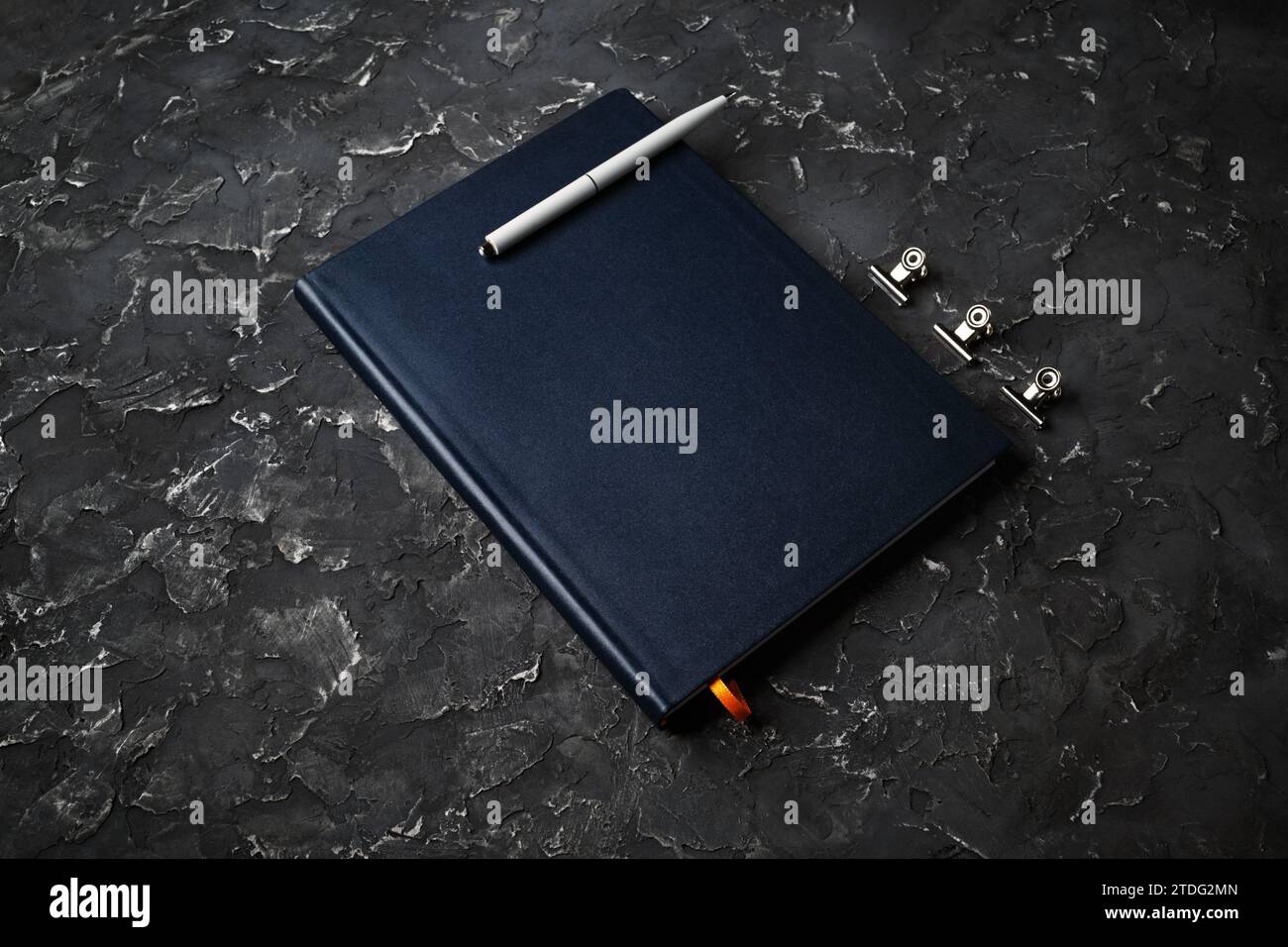 Photo of blank closed notepad and pen on black plaster background Stock ...