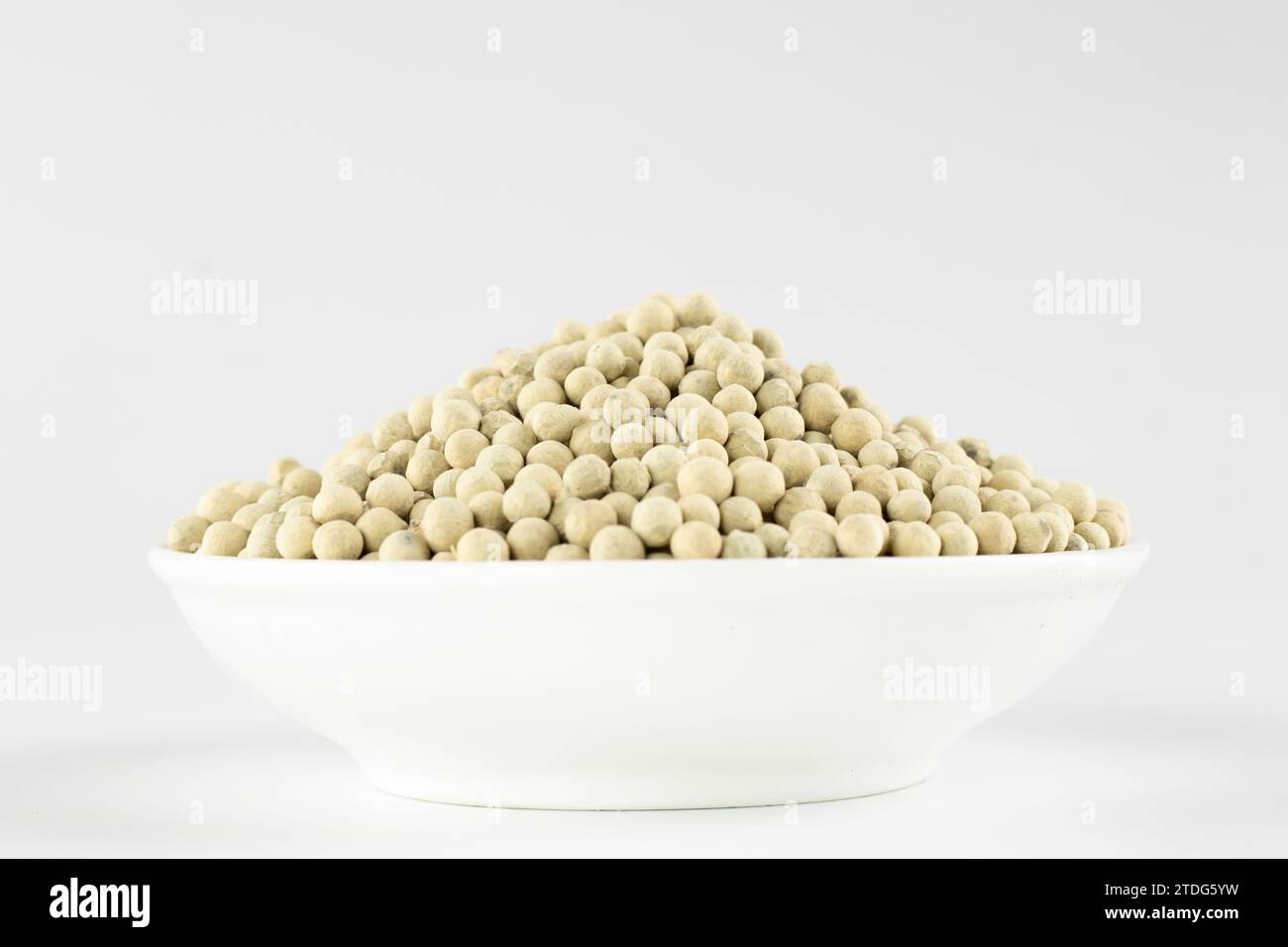 white peppercorns or white pepper in White bowl isolated on white ...