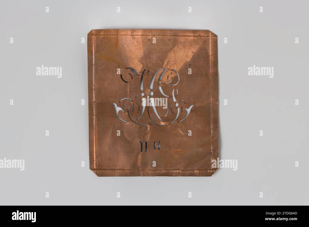Red copper template, rectangular, with punched initials 'HG', very fine ...
