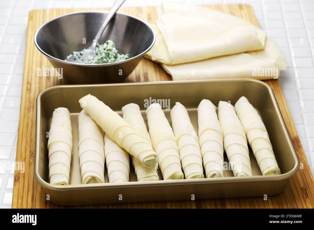making Sigara borek, Cigar-like Turkish spring rolls. A dough sheet ...