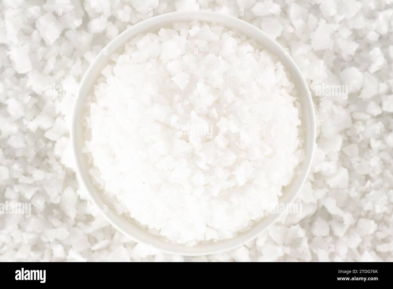 Crystal of Sea Salt in White bowl on Sea Salt background.top view Stock ...