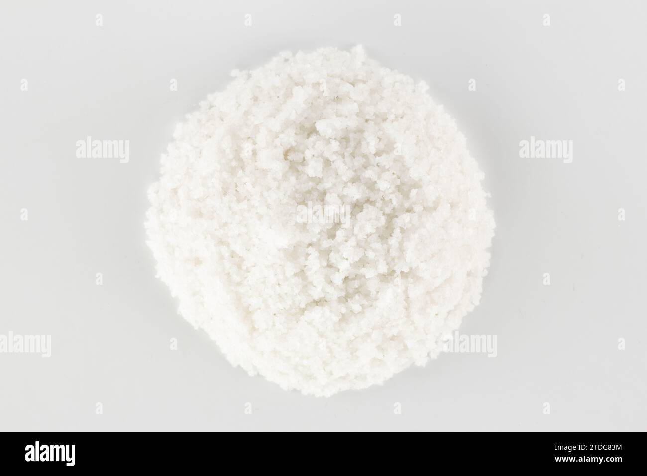 Finely ground Sea Salt piled in circle shape isolated on white ...