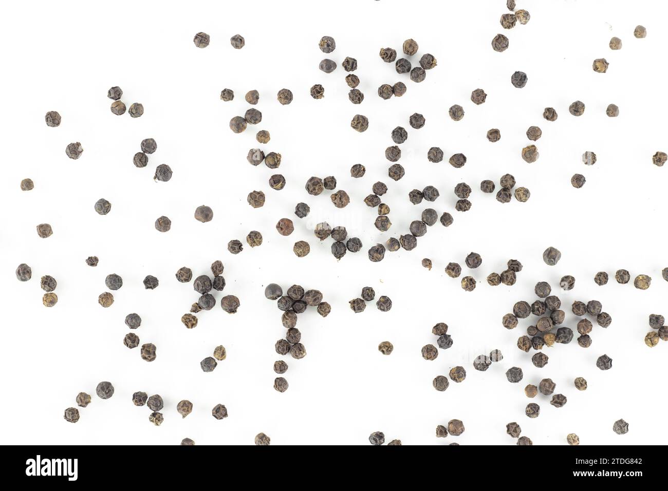 Scattered black pepper placed on a white background Stock Photo - Alamy