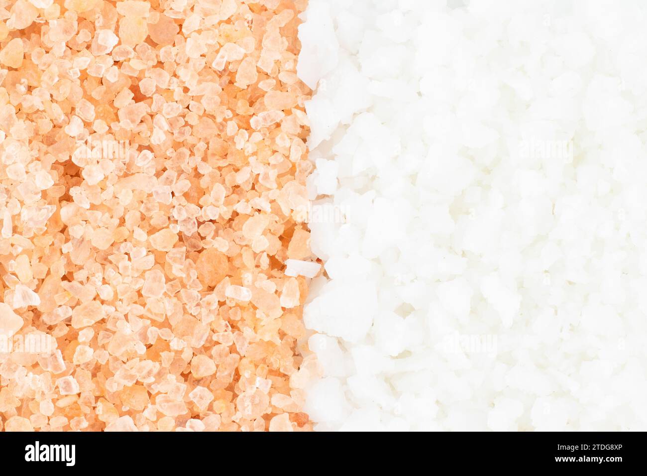 Himalayan Pink Salt background and white Sea Salt background divided in ...
