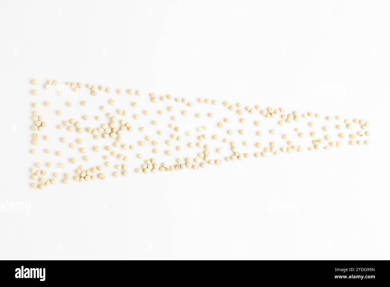 white peppers placed in shapes on a white background.top view Stock ...