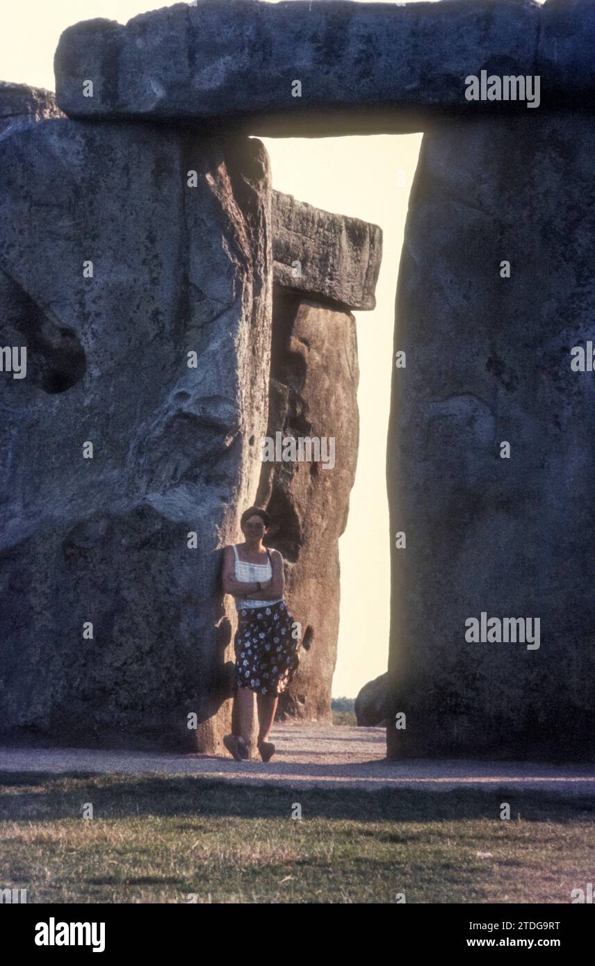 1970s archive photograph of a tourist at Stonehenge, when it was still ...