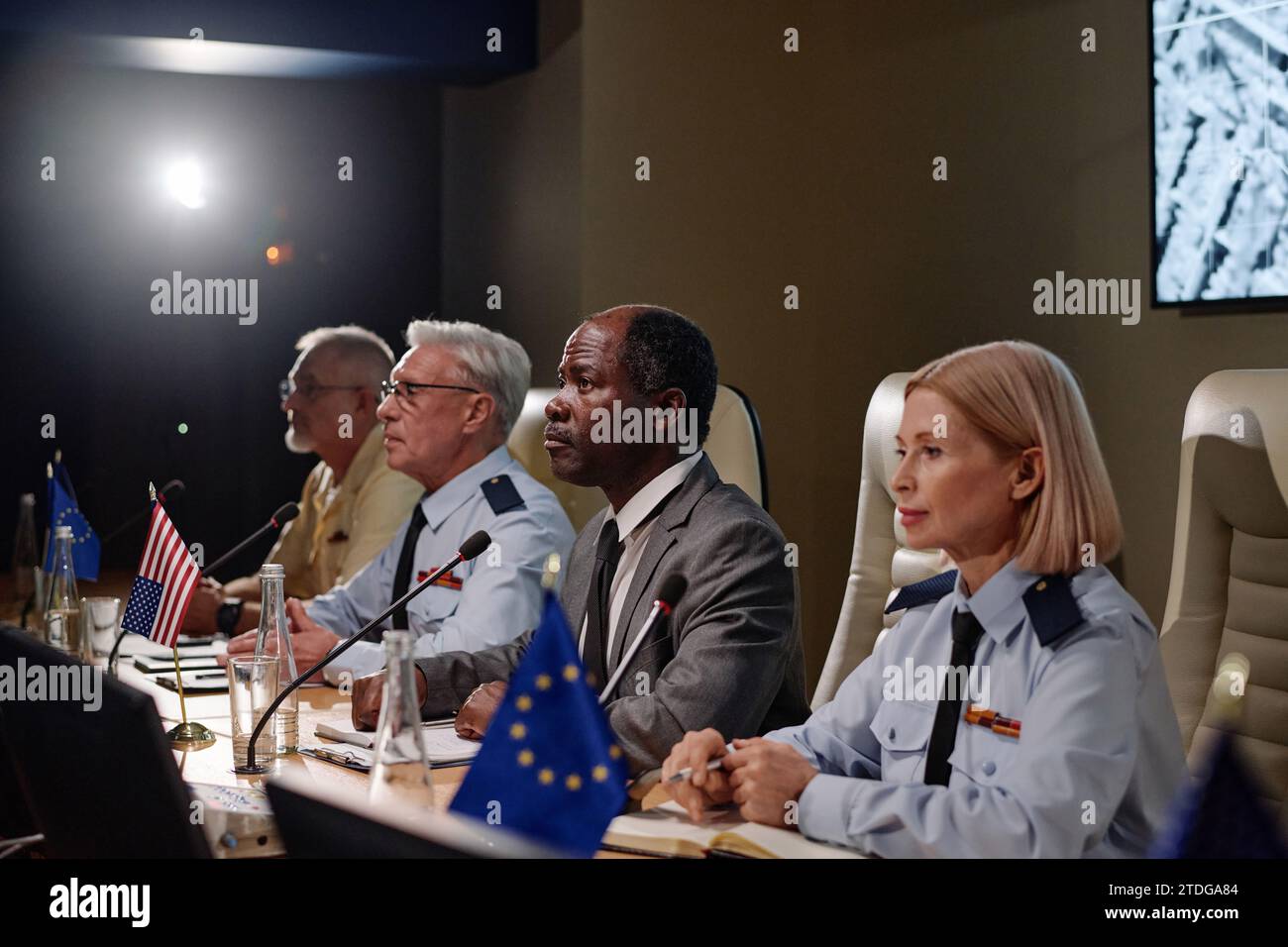 Group of politicians sitting at military conference and giving an ...