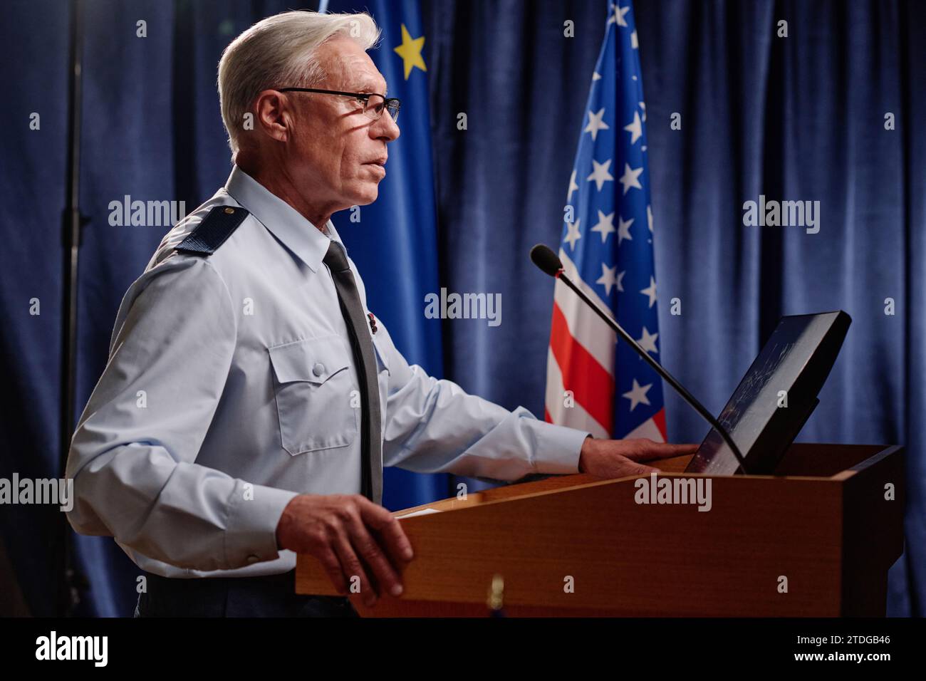 Mature politician speaking in microphone while giving an interview at ...