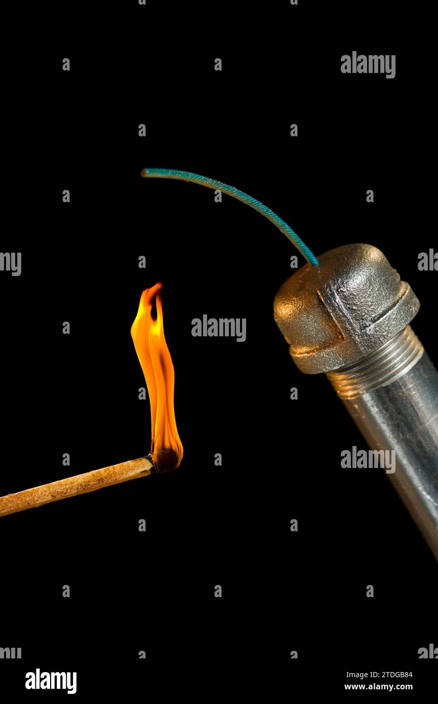 A metal pipe bomb with lit match against a black background Stock Photo ...