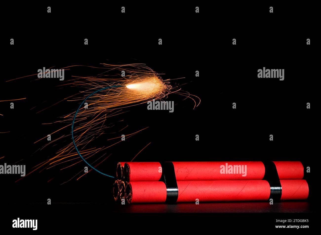 A bundle of dynamite with lit fuse again black background Stock Photo ...