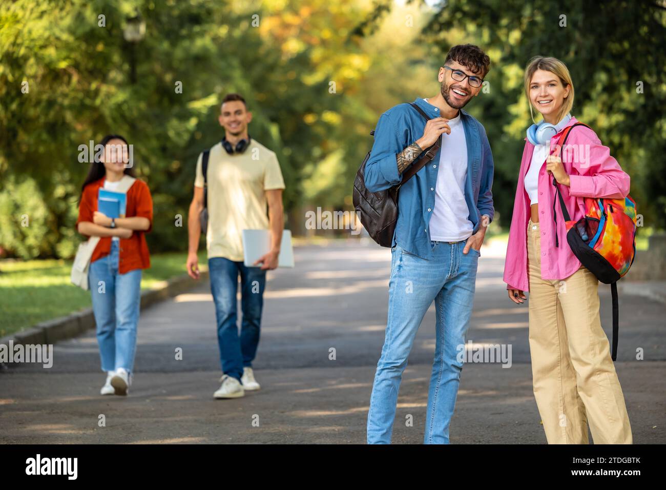 Group of young people having a walk in the park Stock Photo - Alamy