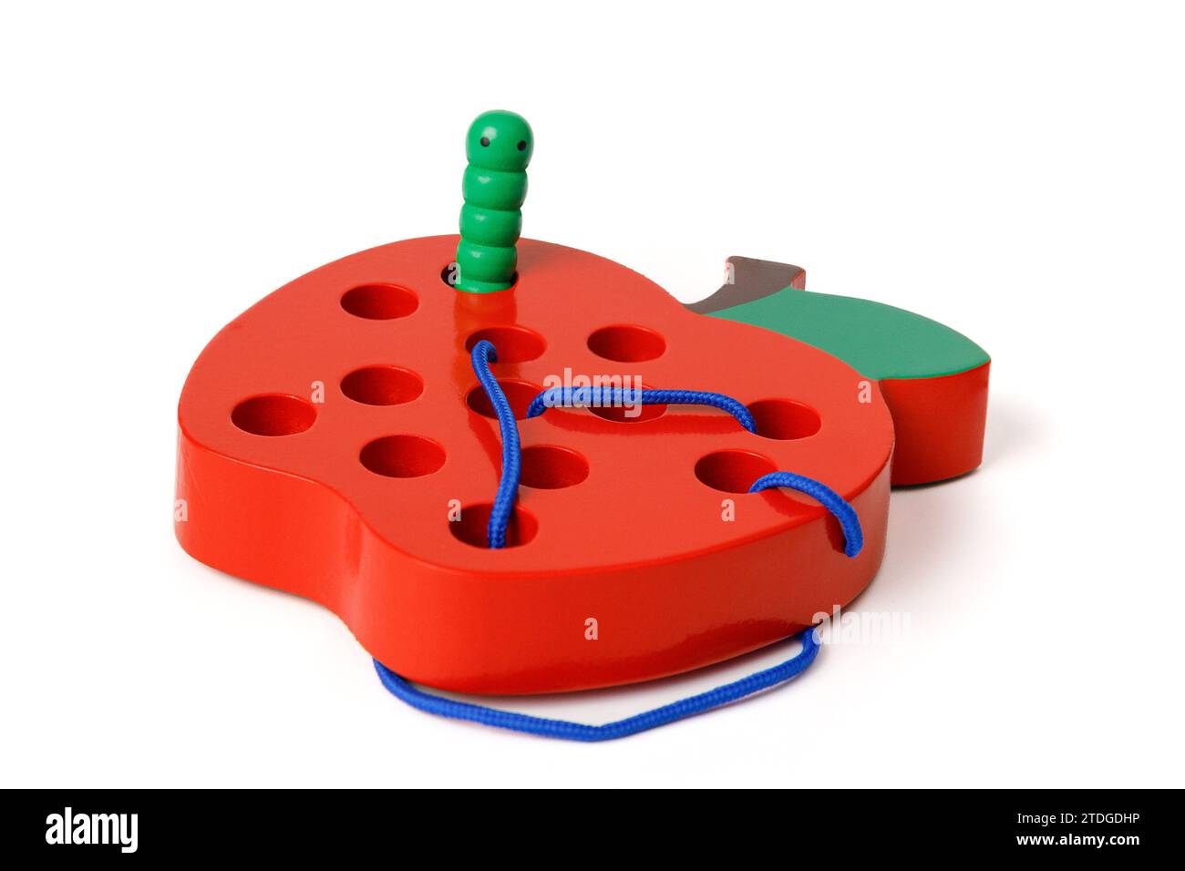 Children's wooden toy in the shape of a red apple with a worm on a rope ...