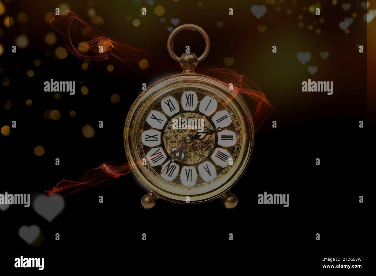 an old golden analog alarm clock with mechanical movement isolated on ...