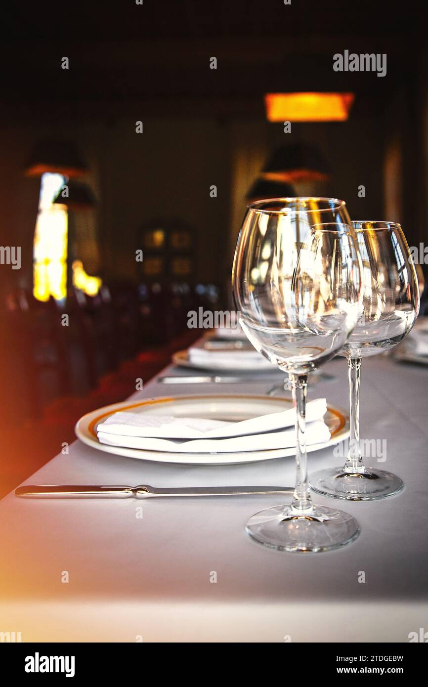 Dining table set with wine glasses by the window in a luxury restaurant ...