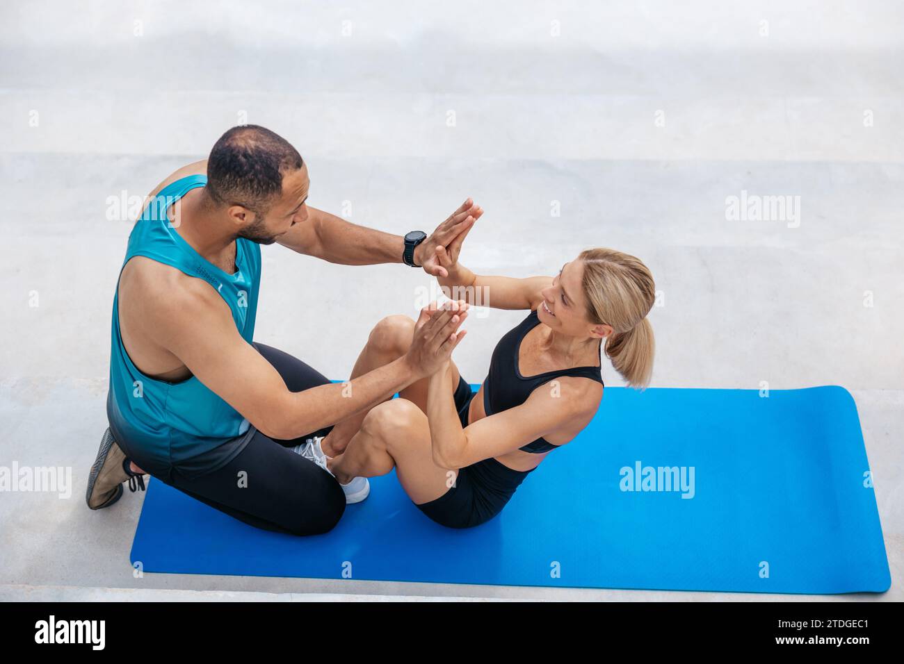 Woman with blonde hair in excellent shape doing sit-ups with her ...