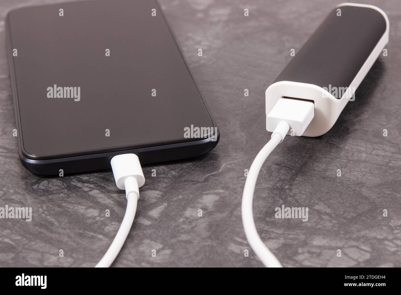 External black powerbank charging empty battery of smartphone or mobile ...