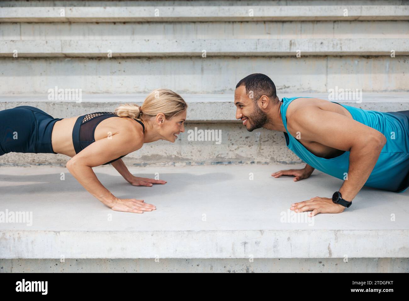 Athletic man and woman couple training push up together outdoor Stock ...