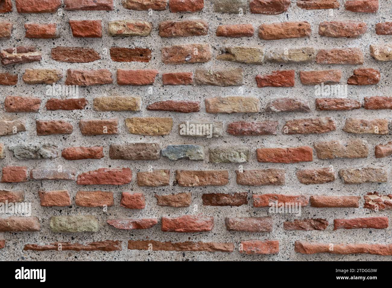 Closeup detail of a section of a brick wall with worn and weathered ...