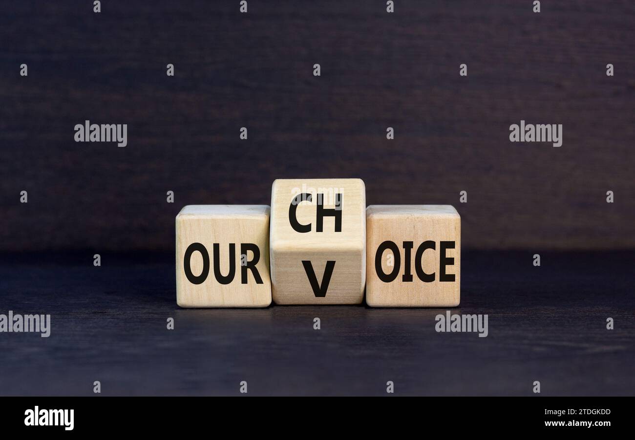 Our voice choice symbol. Businessman turns wooden cube and changes ...