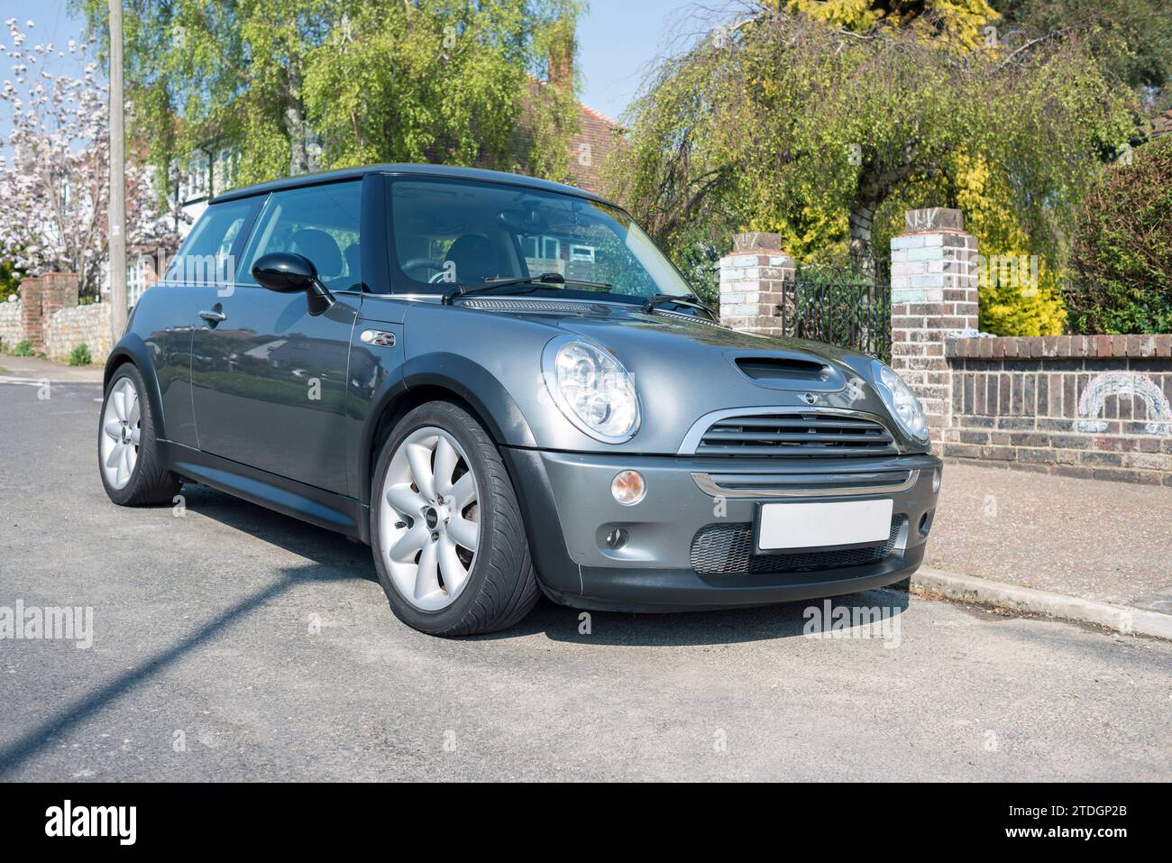 A Mini Cooper S from 2005 is parked in front of a residential house on ...