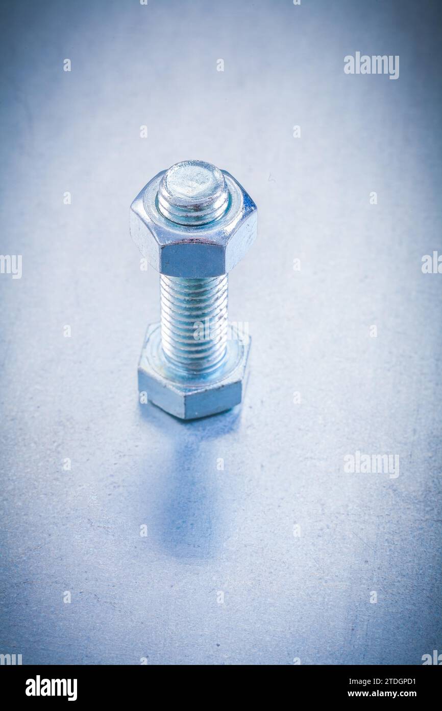 Threaded screw bolt with construction nut on metallic background ...