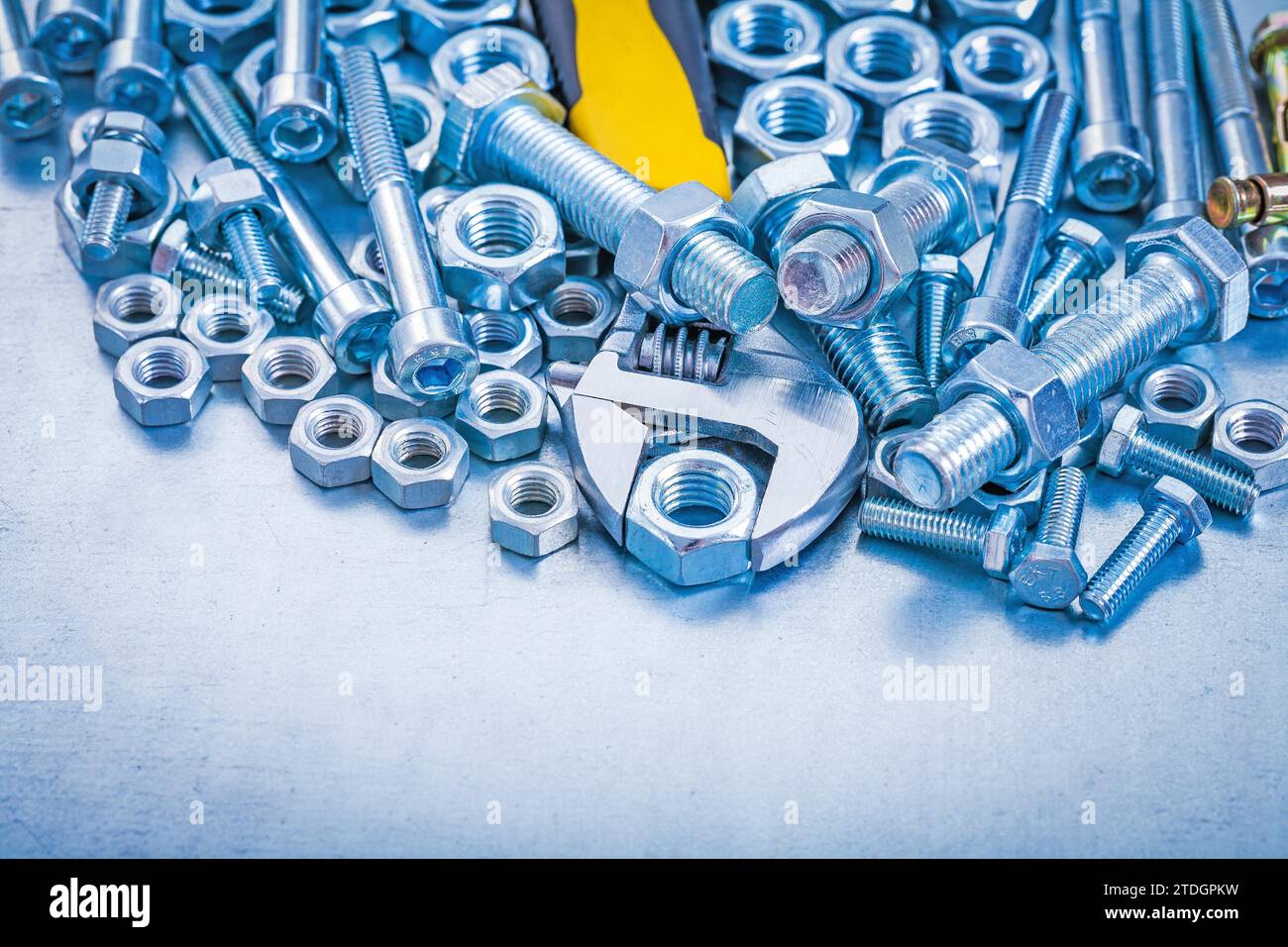 Adjustable key stainless bolt details and nuts on metallic background ...