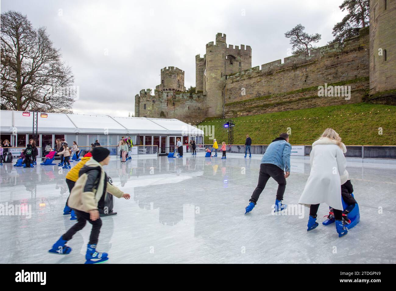 People skating on the temporary mobile artificial ice rink as part of ...