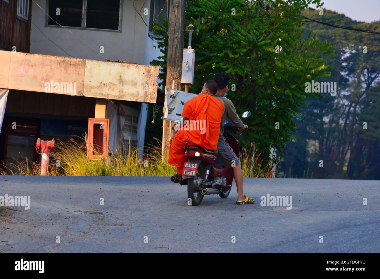 Monk on motorcycle, sitting sideways like a woman Thailand Stock Photo ...