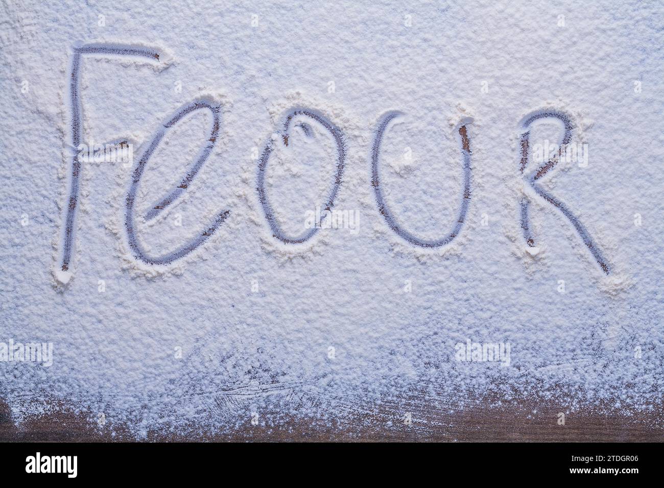 Inscription of hands on flour with dark wood surface Advertising sign ...