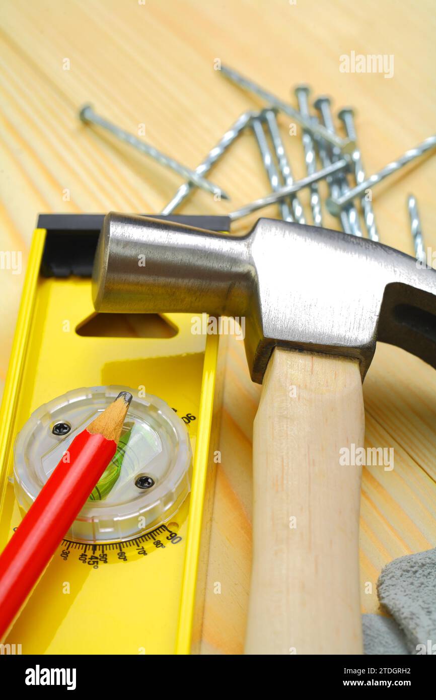 Hammer and spirit level with pencil nails Stock Photo - Alamy