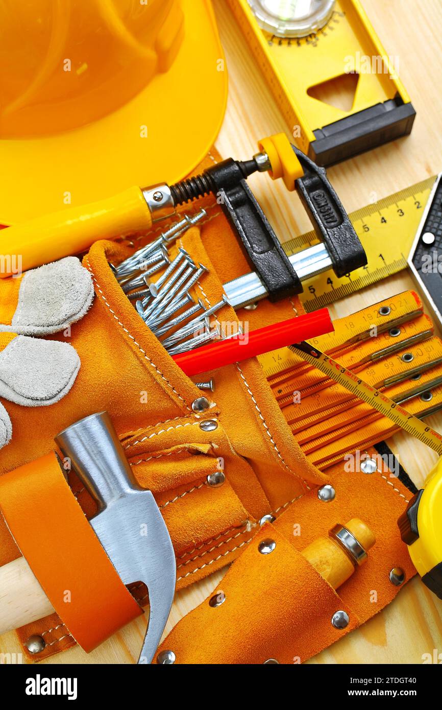 Construction tools in belt and hard hat Stock Photo - Alamy